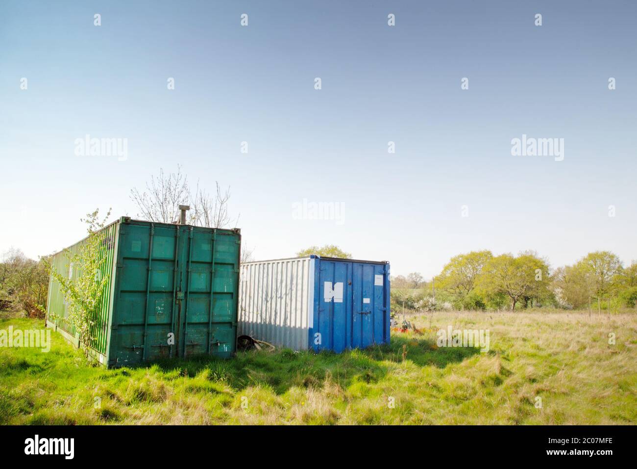 large metal shipping containers in a field Stock Photo - Alamy
