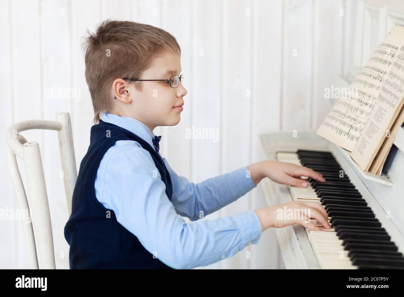 Boy playing piano Stock Photo - Alamy
