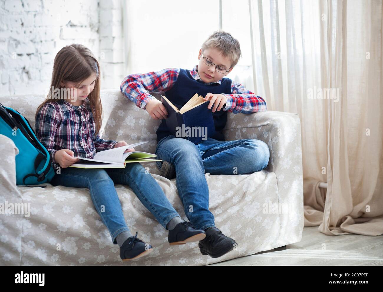 Children readind book in living room Stock Photo - Alamy