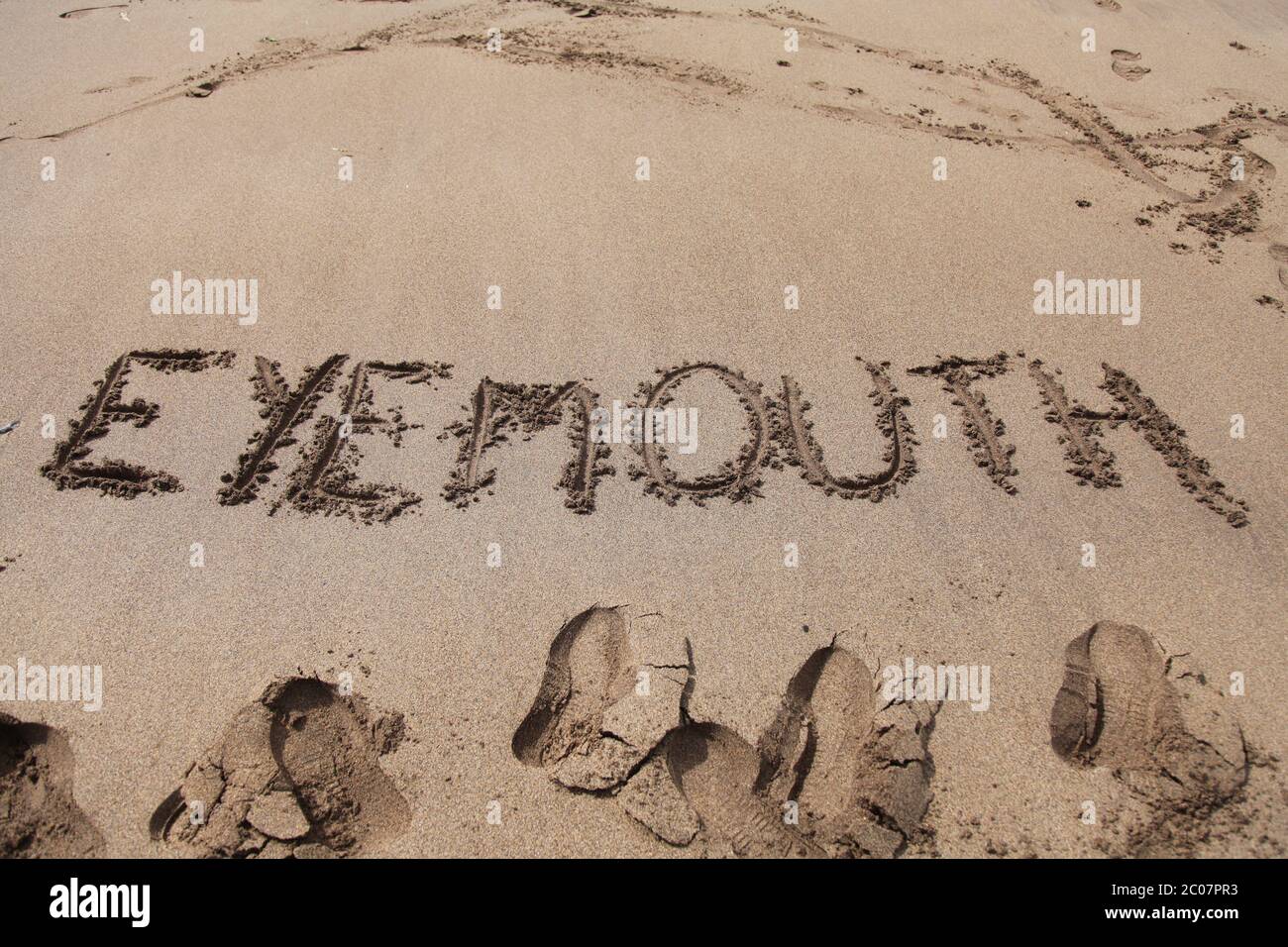 Eyemouth word written in the sand at Eyemouth beach with footprints ...