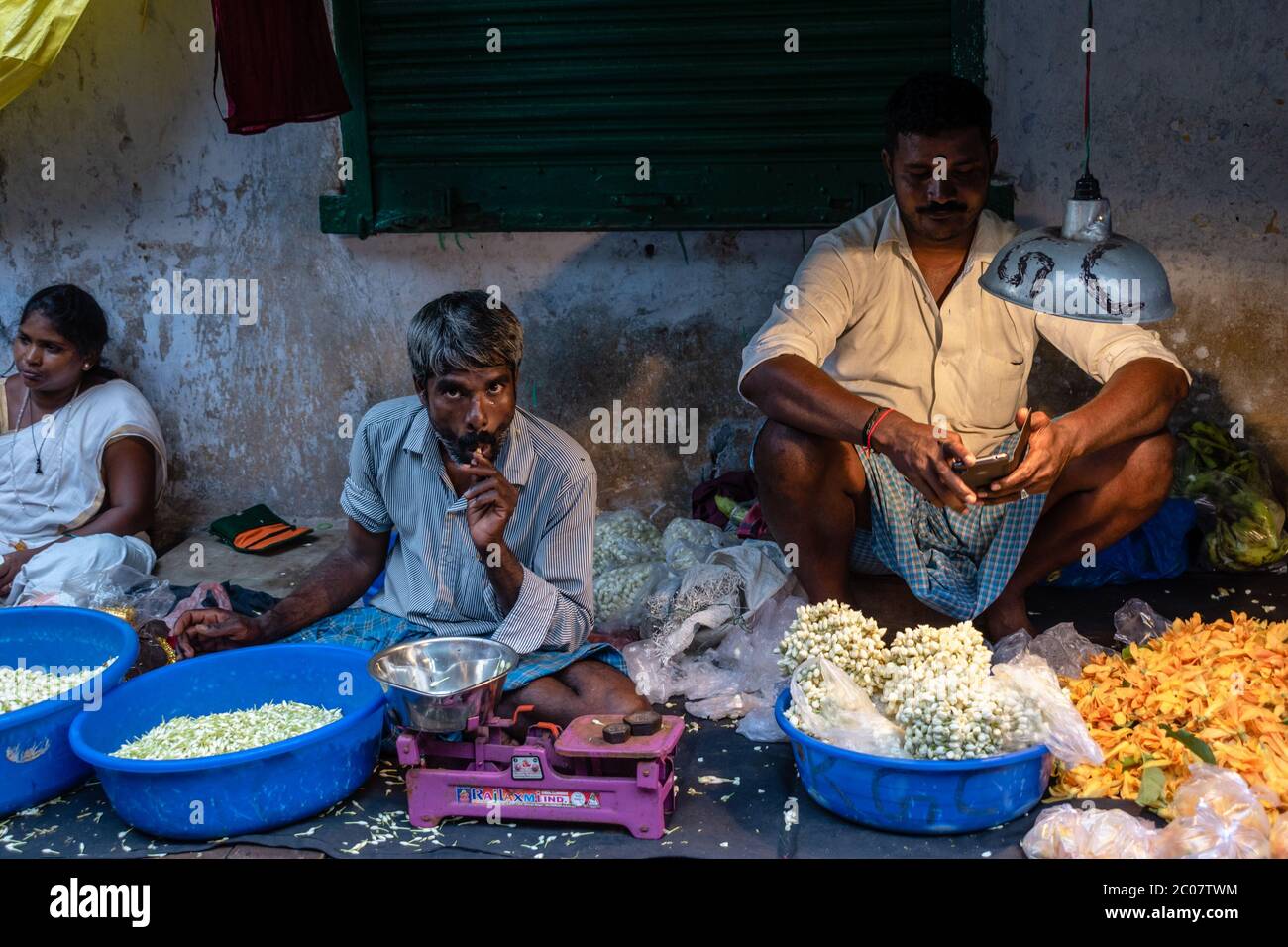 Chennai, Tamil Nadu, India - August 2018: Portrait of an Indian flower seller in his shop on the ...