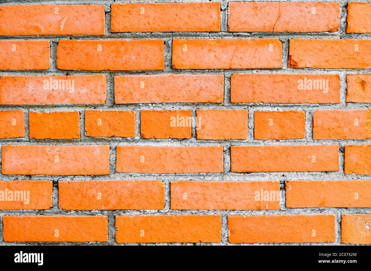 Brick wall of orange brick, in the middle row of bricks with butt Stock ...