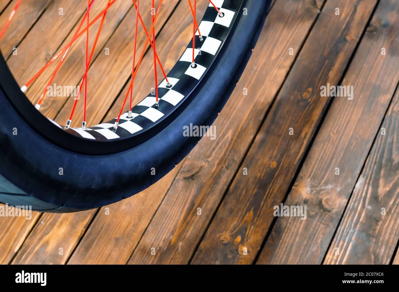Wheel of a stylish bicycle with a black and white rim and a black ...