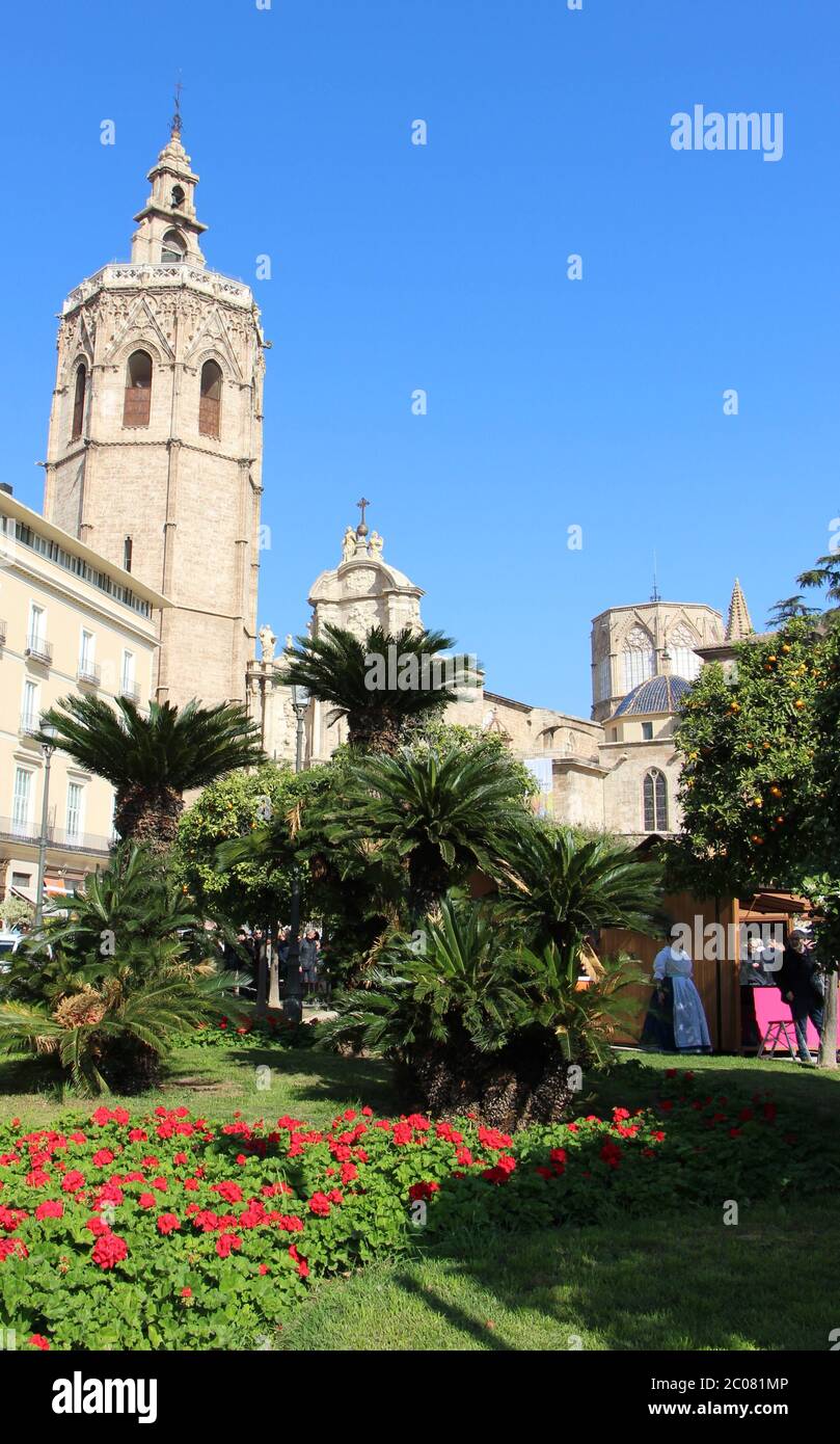 View of the bell tower of Valencia cathedral from gardens with red ...