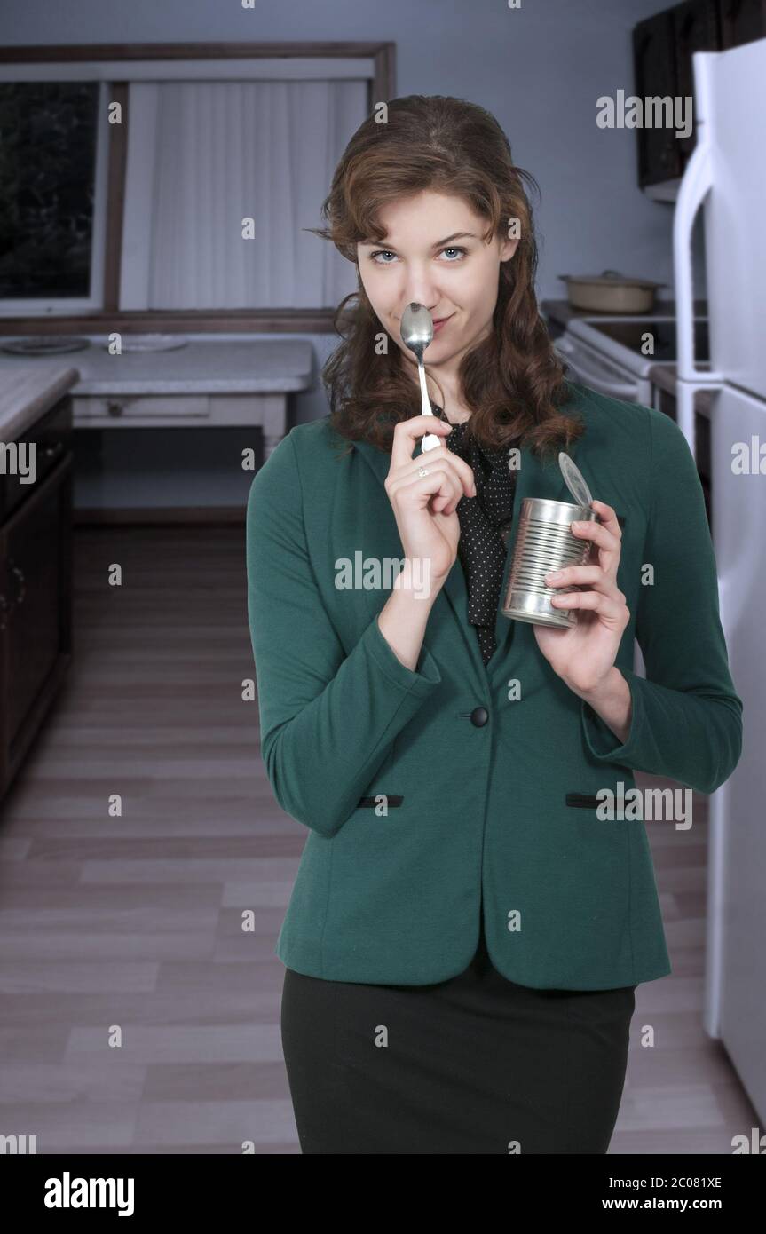 Woman eating from a can Stock Photo - Alamy