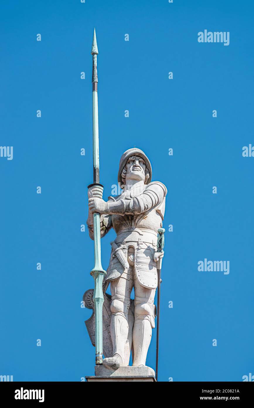Very old statute heavy armed gatekeeper, medieval warrior with spire in ...