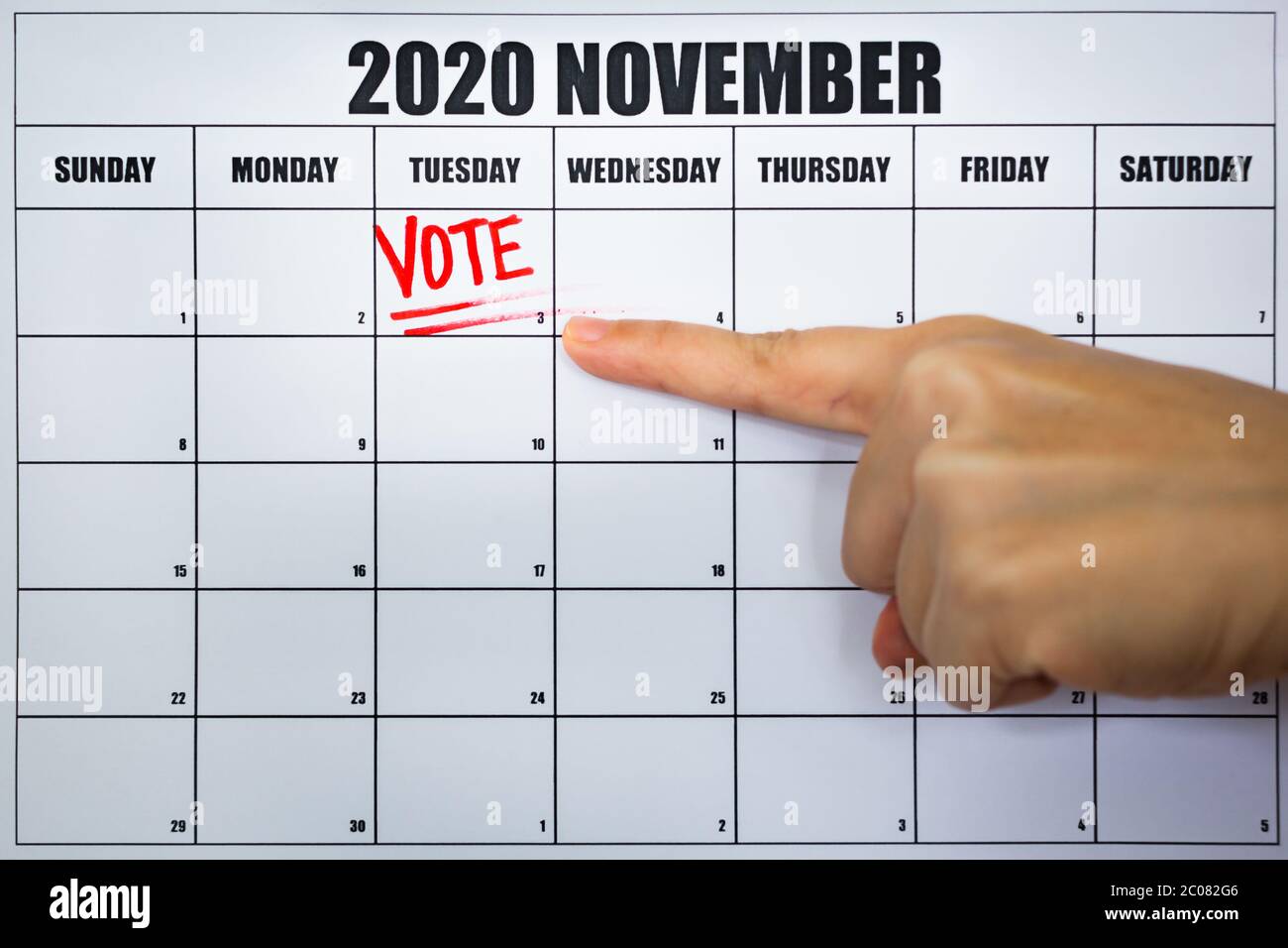 Vote now concept on a calander with a hand pointing at it Stock Photo ...