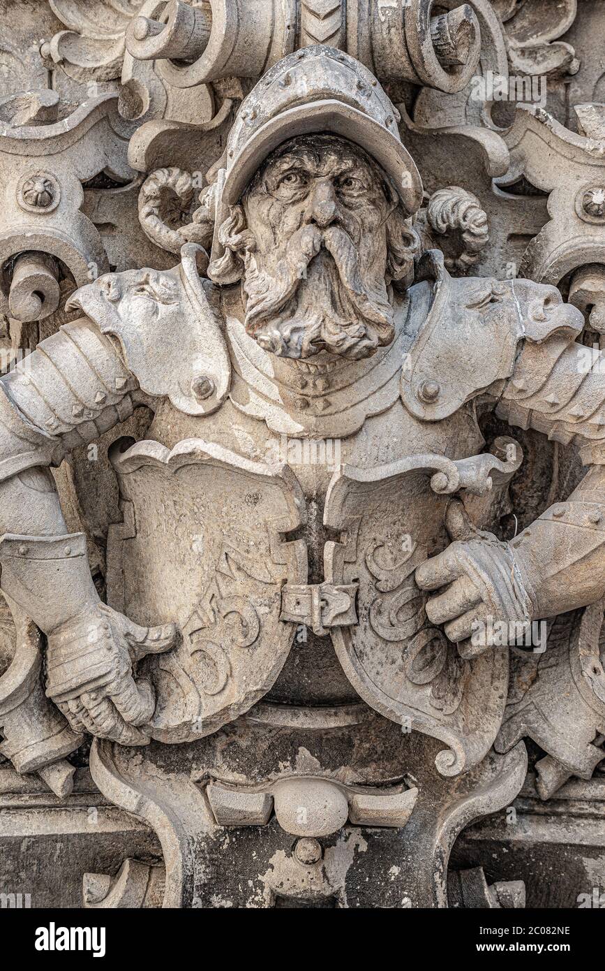 Very old statute of scary and heavy armed gatekeeper, medieval warrior ...