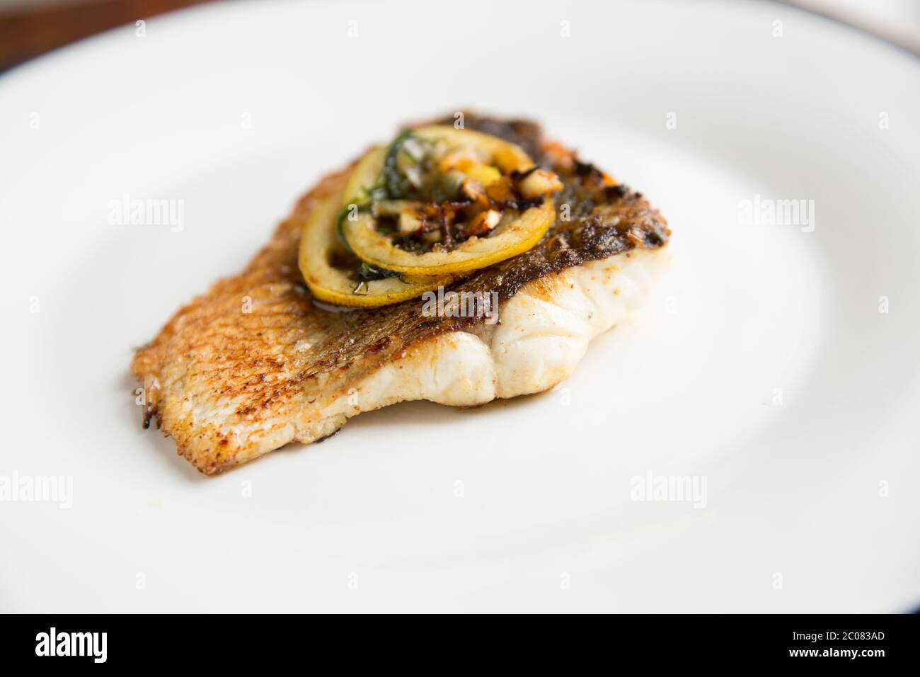 A fried fillet from a bass, Dicentrarchus labrax, that was caught at ...