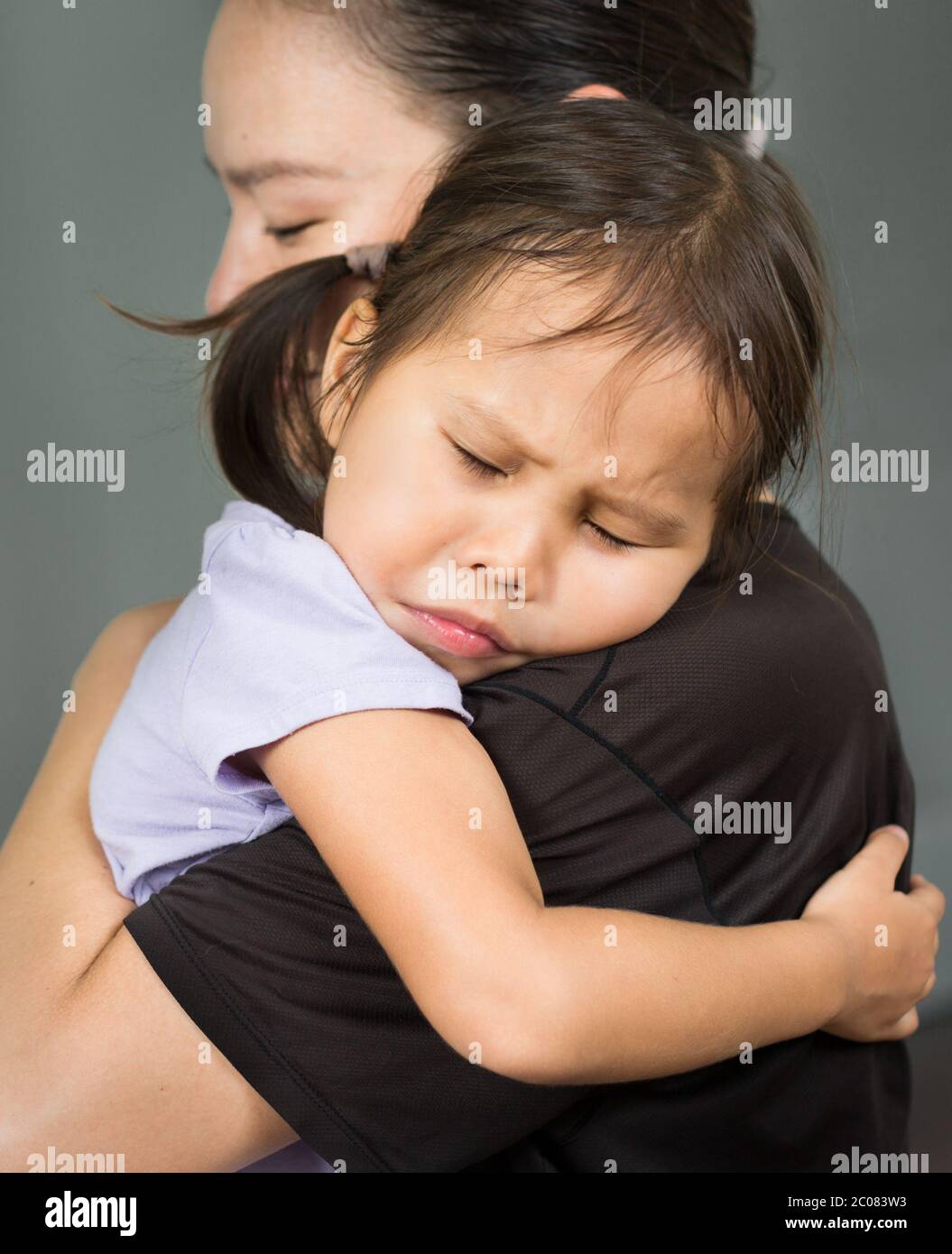Young toddler holding her mother to feel safe and secure. Family love ...