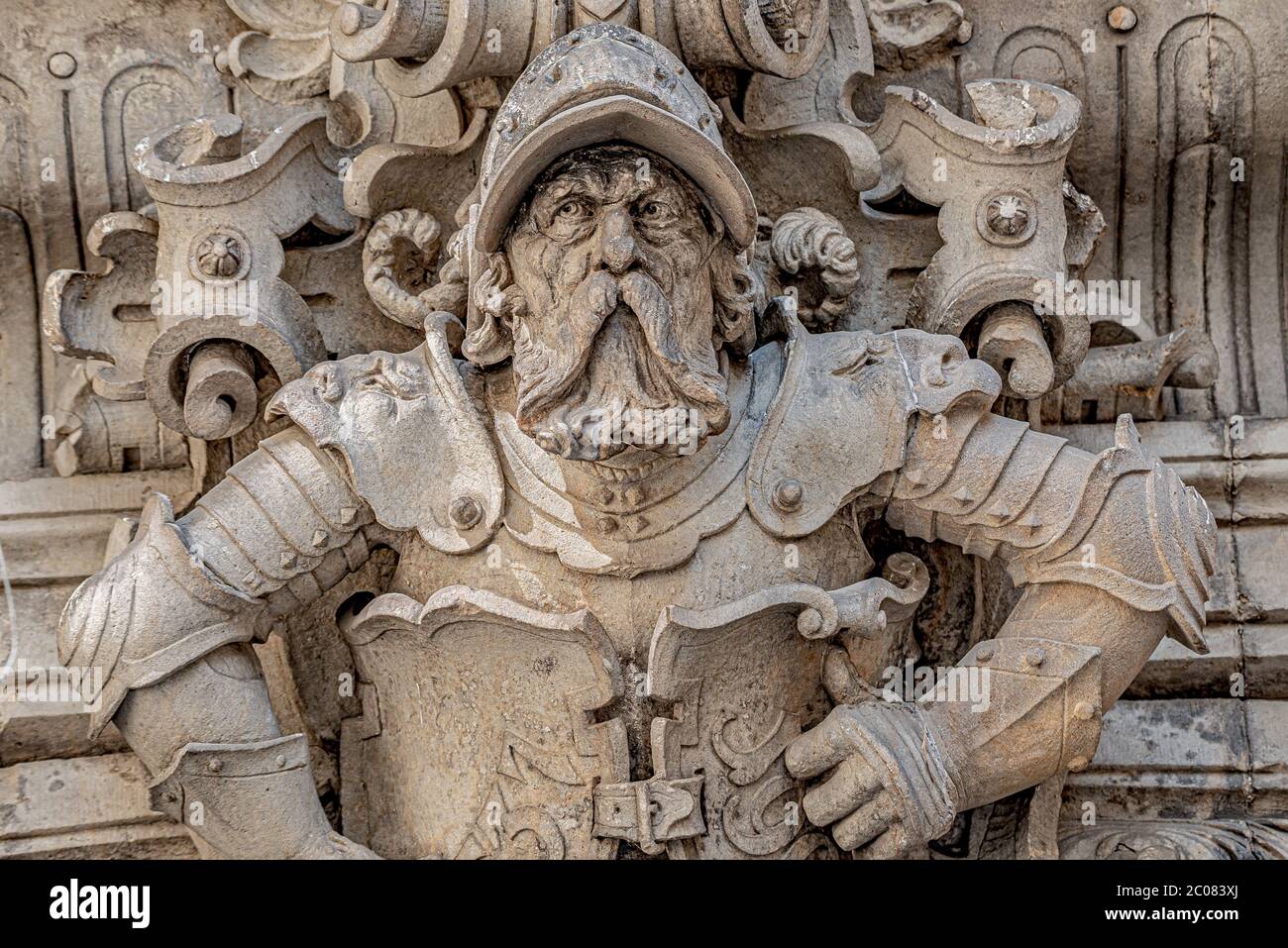 Very old statute of scary and heavy armed gatekeeper, medieval warrior ...
