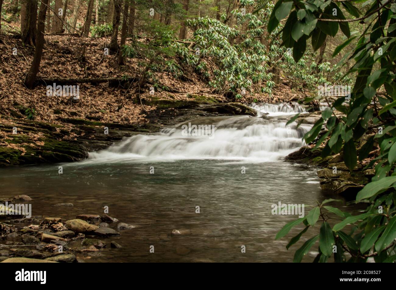 Mountain stream cascades over an outcrop Stock Photo - Alamy
