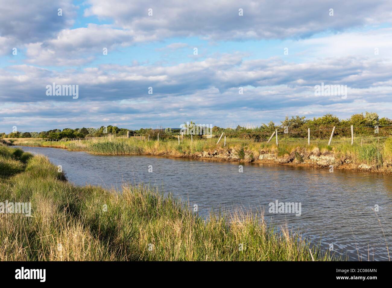 Hikers view of Little Deep at Thorney Island in West Sussex. River ...