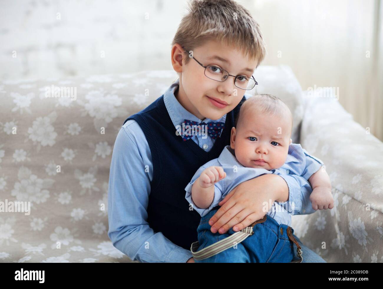 Loving brother holding his little baby brother Stock Photo - Alamy