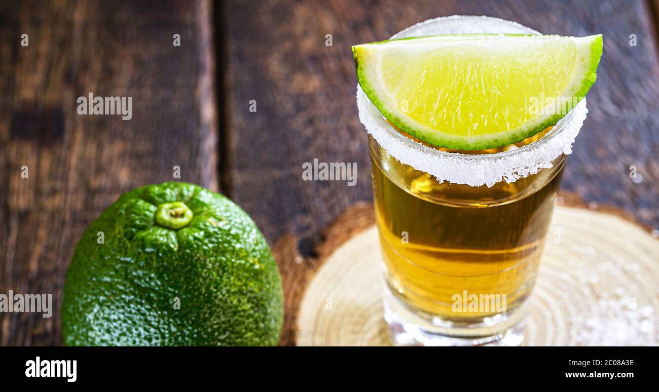 glass of tequila, distilled alcohol drink with salt on the rim of the ...