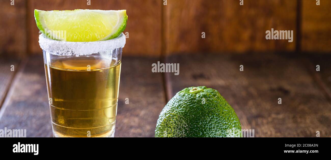 glass of tequila, distilled alcohol drink with salt on the rim of the ...