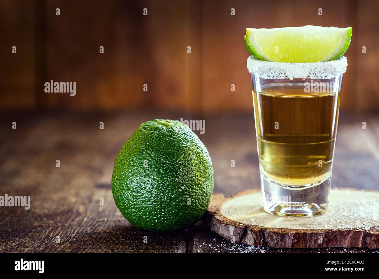 glass of tequila, distilled alcohol drink with salt on the rim of the ...