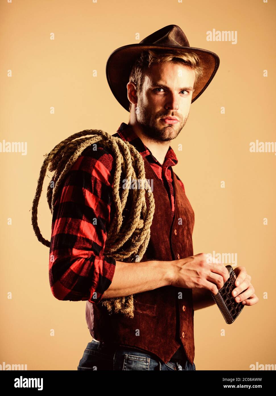 have a drink. wild west rodeo. man in hat drink whiskey. man checkered ...