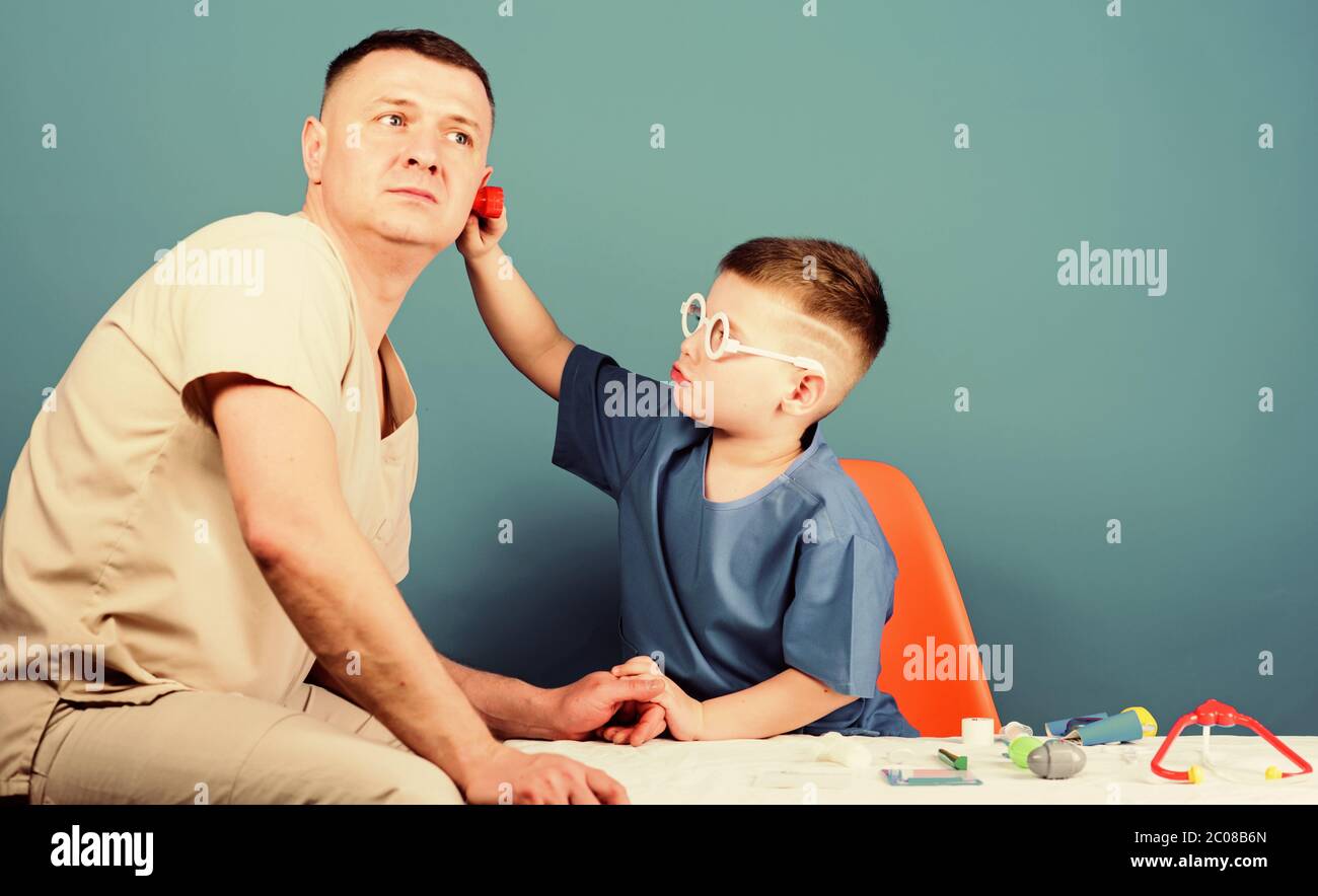 family doctor. happy child with father with stethoscope. medicine and ...