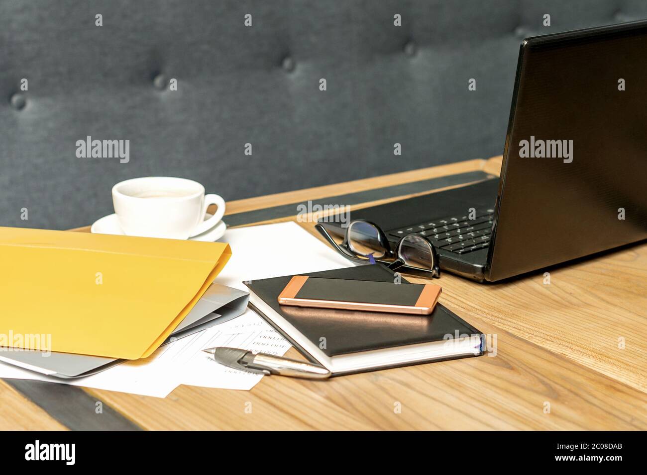 Office workplace with laptop, cup of coffee and paperwork without ...