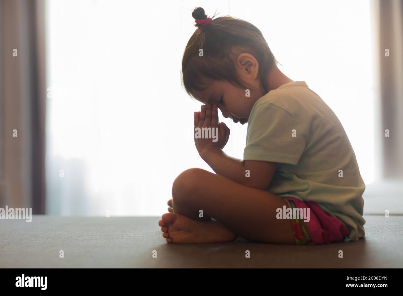 Adorable kid sitting crossed legs hi-res stock photography and images ...