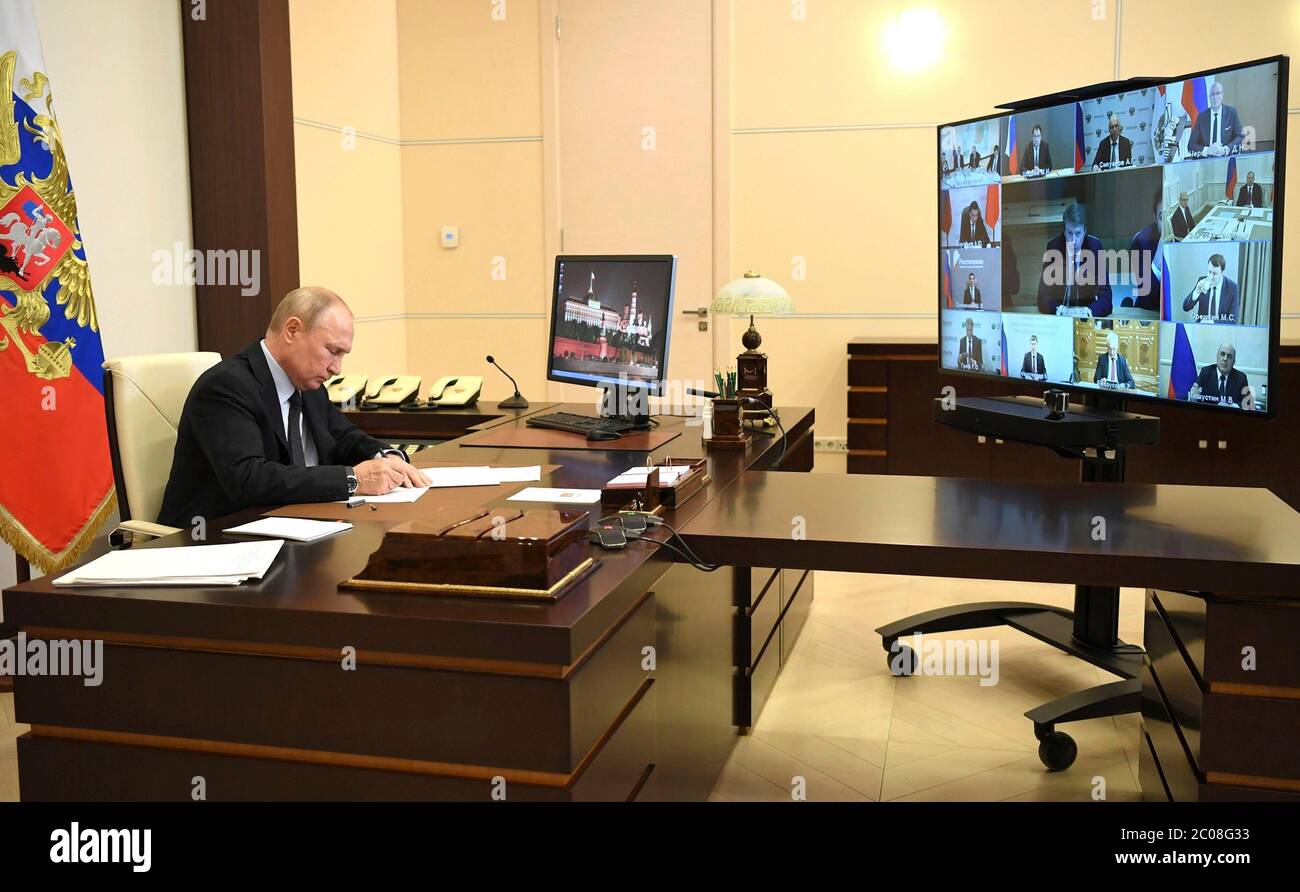 Russian President Vladimir Putin, chairs a meeting via video conference ...