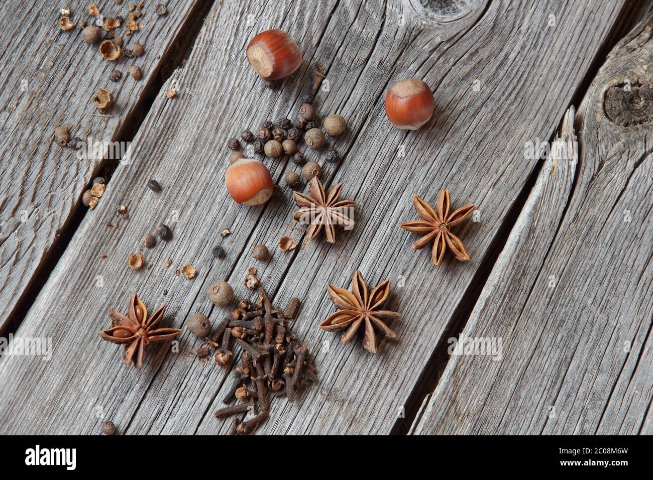 Carnation, fragrant pepper, wood nut and anise asterisks on a wooden ...