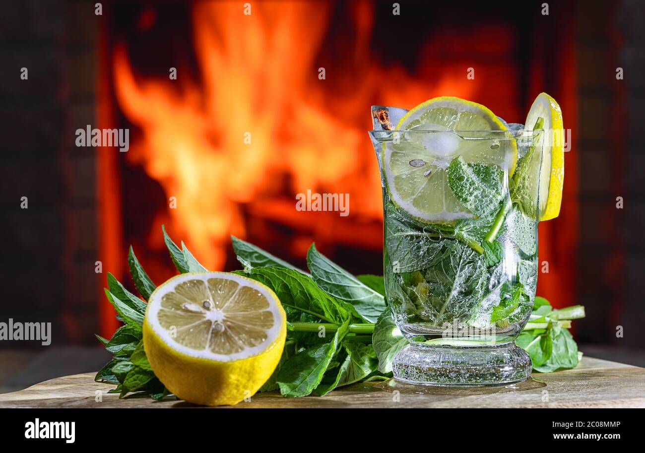Glass of lemonade made from mineral water, lemon ,mint and ice on a ...