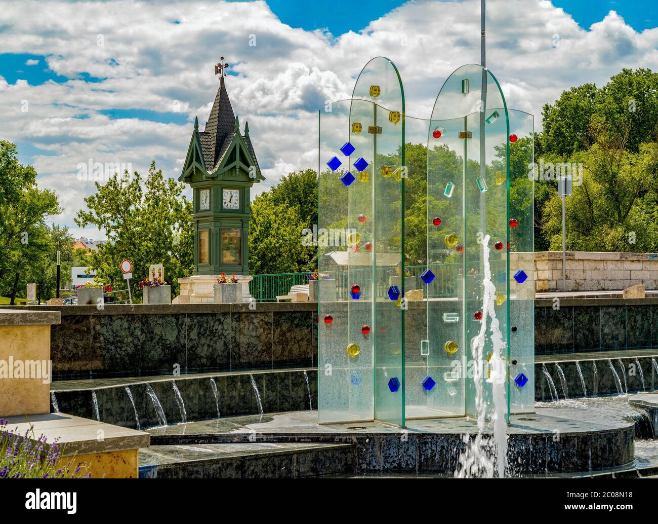 Colorfully decorated fountain and a wooden clock tower at the Vienna's ...