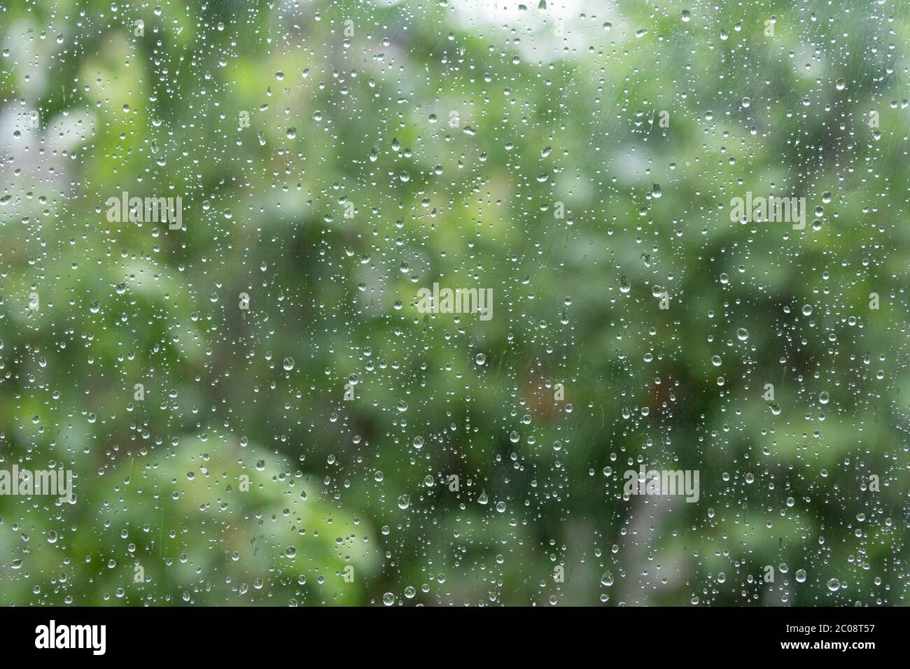 Raindrops on a window pane from the inside of a house Stock Photo - Alamy