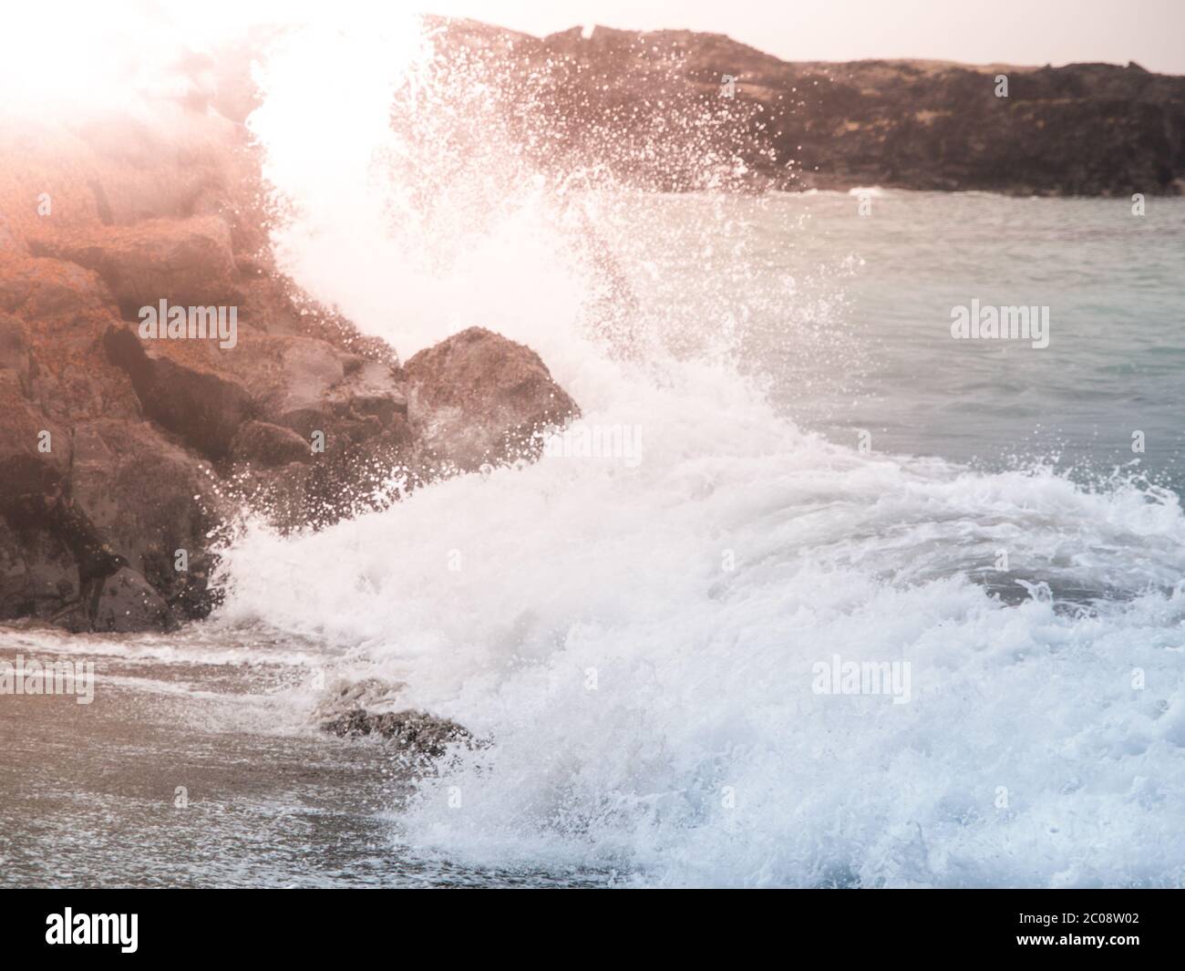 Water splash of breaking wave on the rocky shore Stock Photo - Alamy