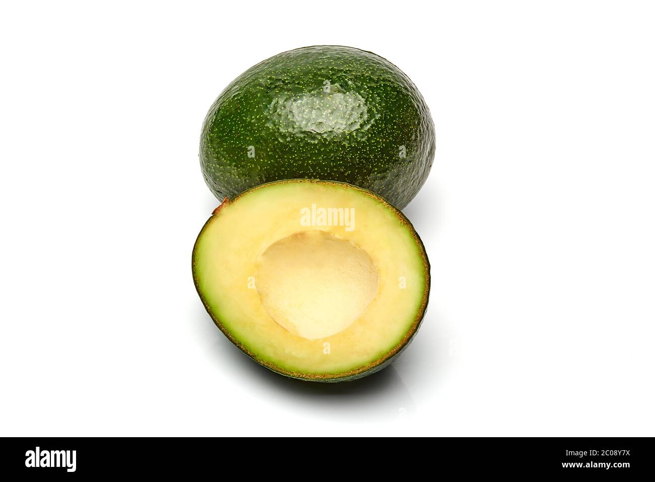 Avocado cut in half, shot on white background Stock Photo - Alamy