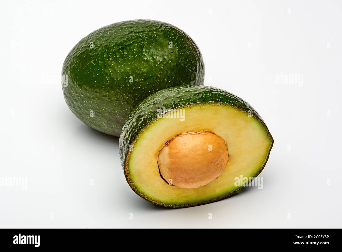 Avocado cut in half, shot on white background Stock Photo - Alamy