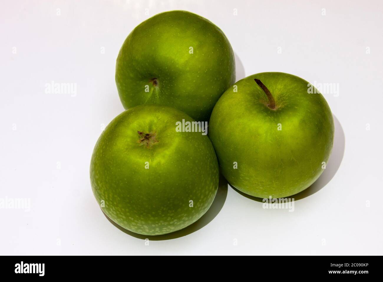 Green Granny Smith apples on a white background Stock Photo - Alamy