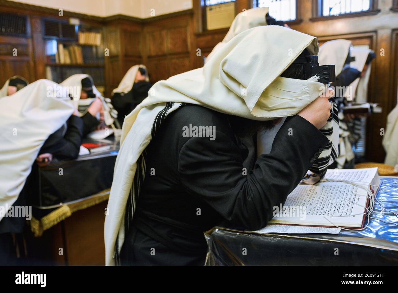 Jewish worshippers cover their eyes during morning prayers. In the ...