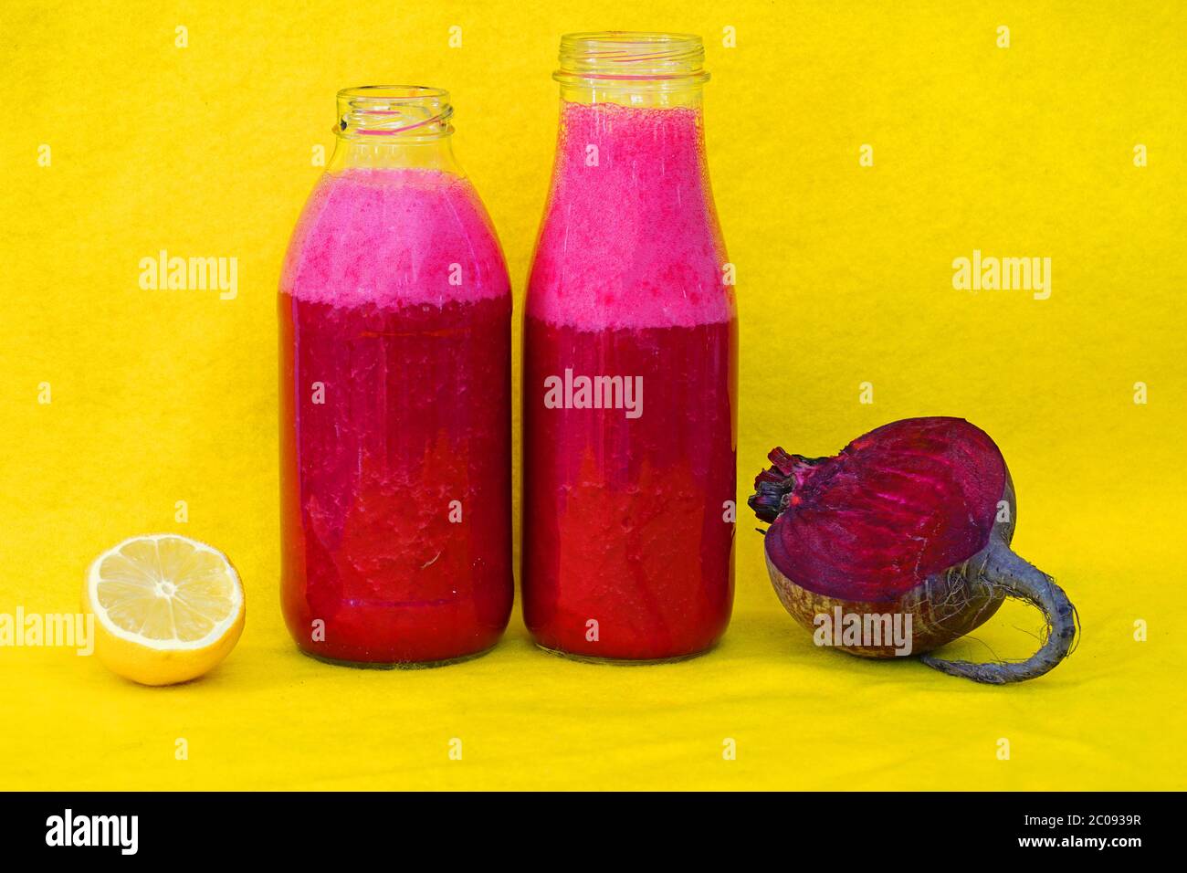 Glass bottles filled with colorful fresh homemade beet and lemon ...