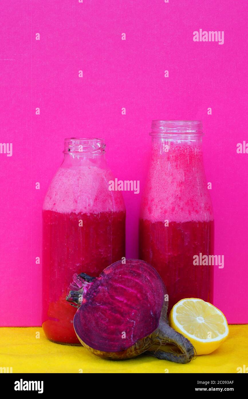 Glass bottles filled with colorful fresh homemade beet and lemon ...