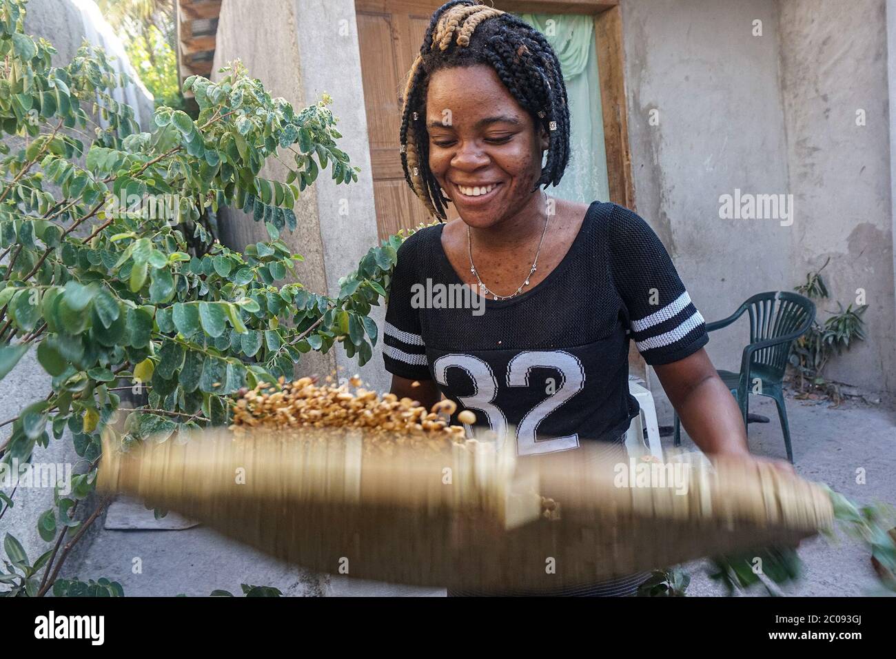 Lora Elmise prepares peanuts to be processed into peanut butter in a ...