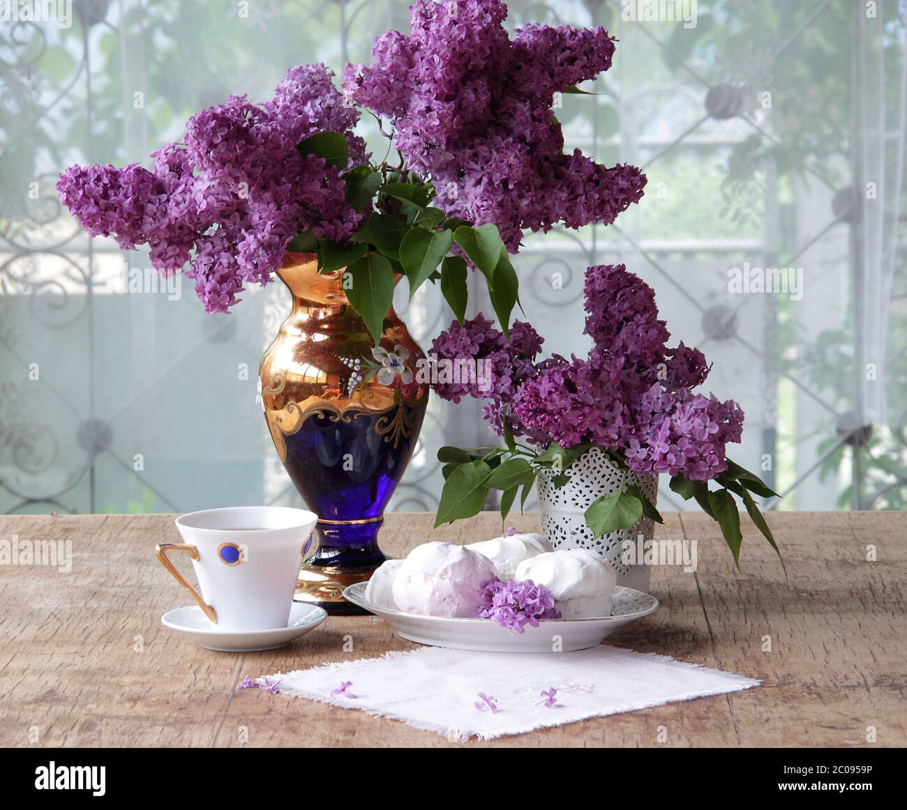 Still-life with a zephyr, a cup of tea and a lilac Stock Photo - Alamy