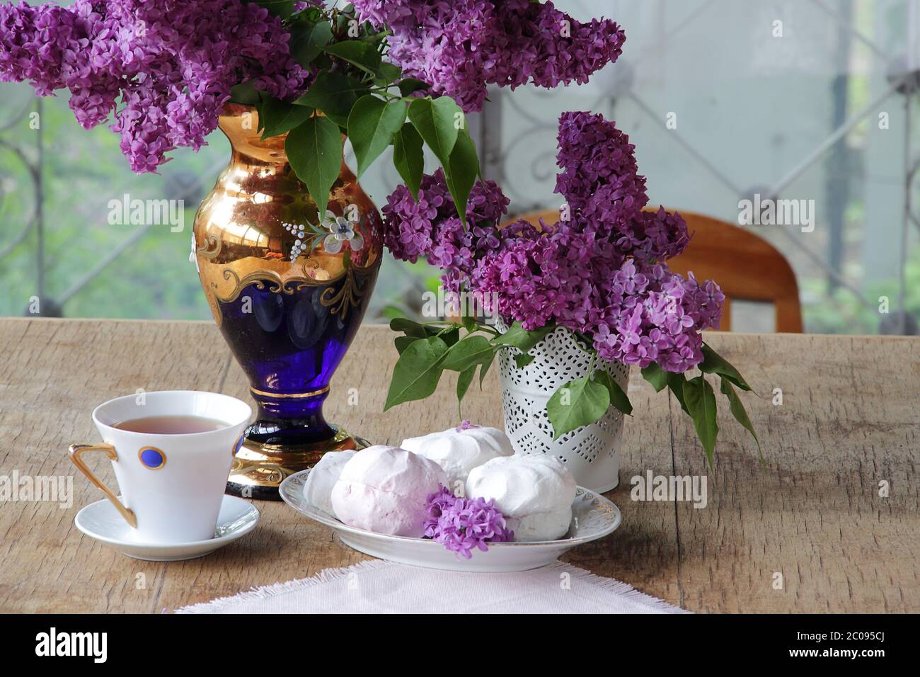 Still-life with a zephyr, a cup of tea and a lilac Stock Photo - Alamy