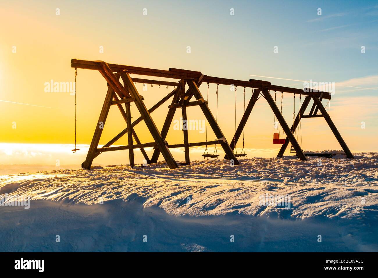 Empty swings in children playground at sunset time Stock Photo - Alamy