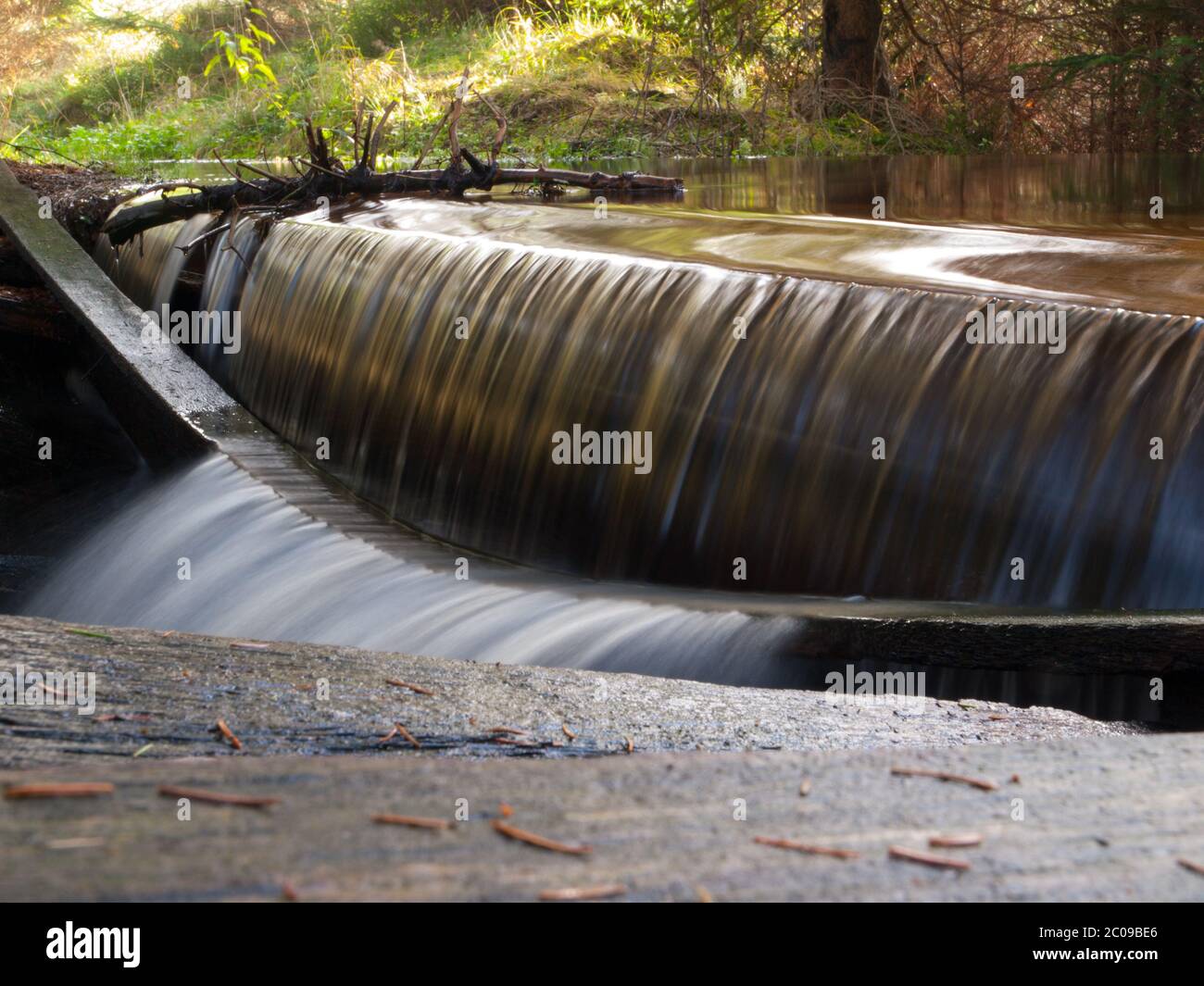Small broken spillweir in the forest, long exposure Stock Photo - Alamy