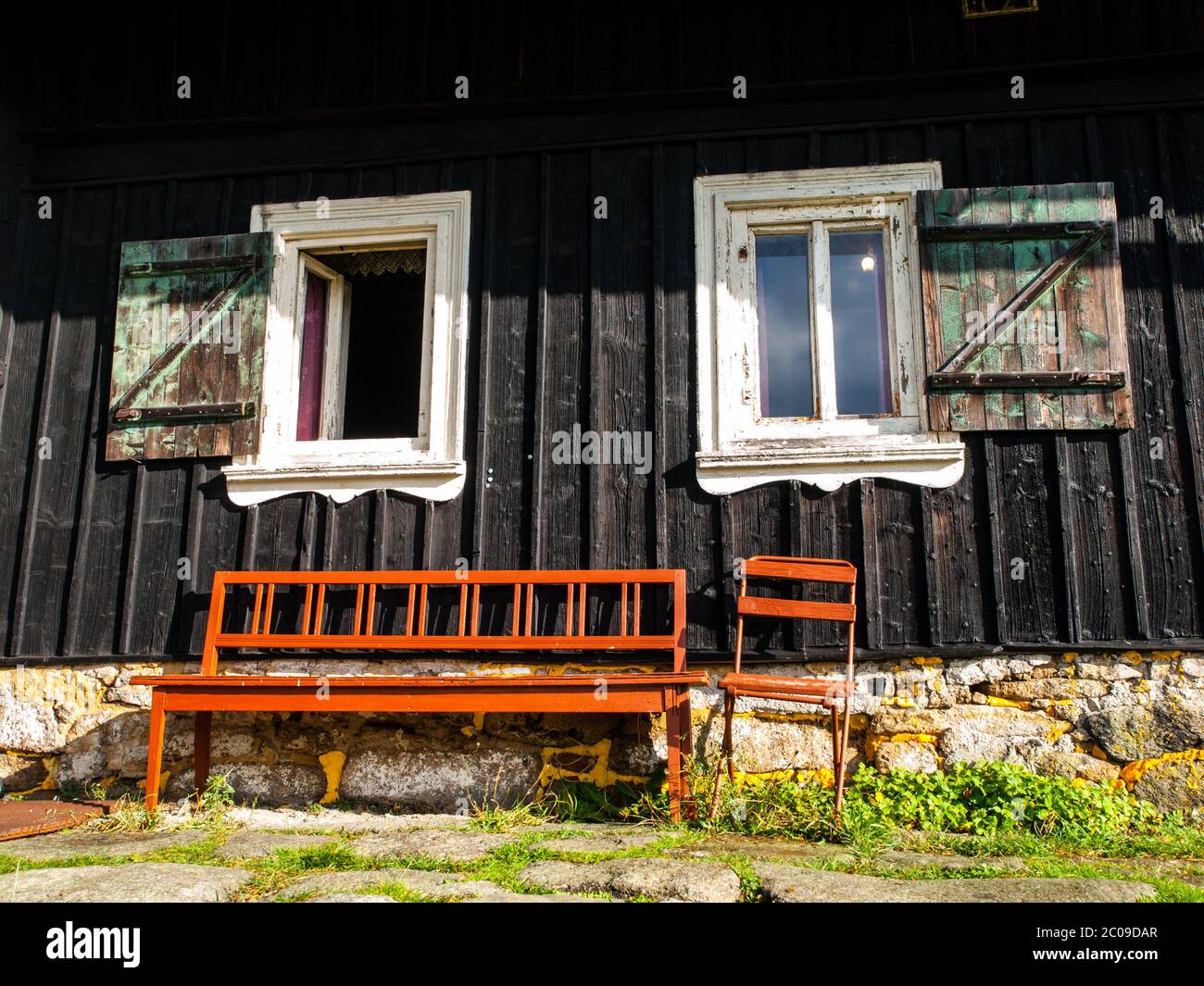 Brown bench at doorstep of wooden cottage Stock Photo - Alamy