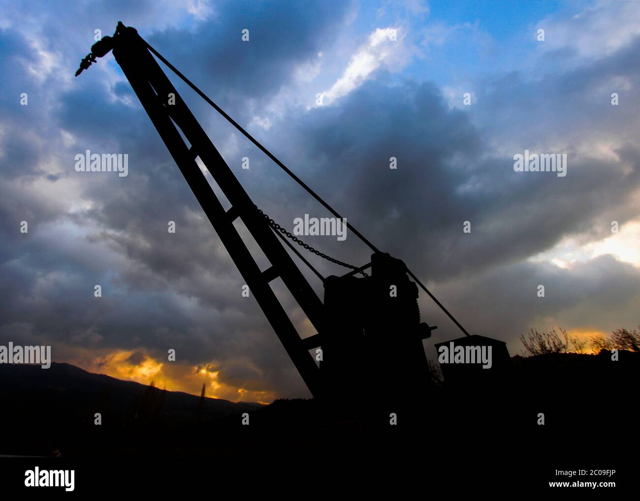 Low angle view silhouette of a short crane, in front of cloud cast ...