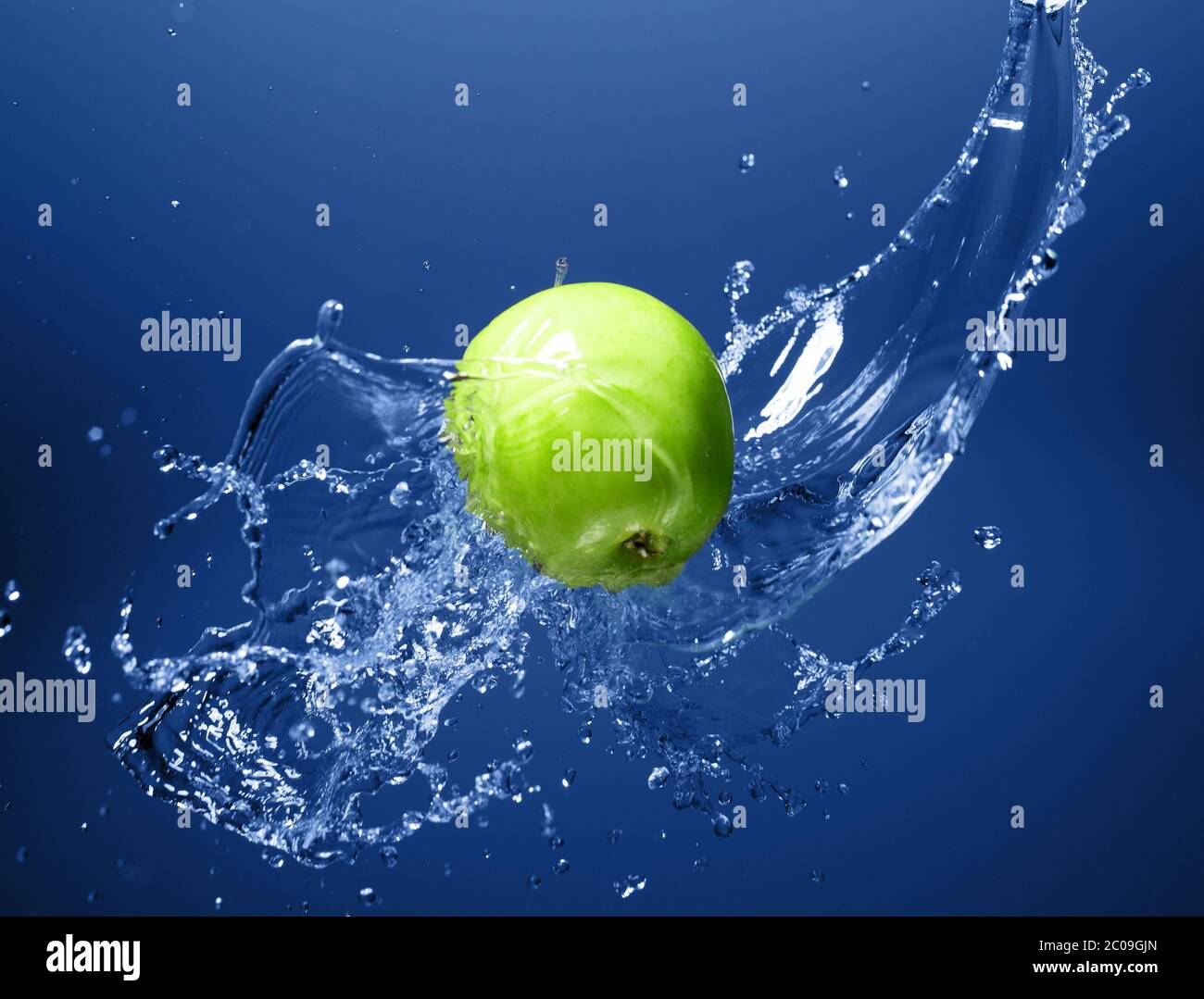 Green apple with water splash, on blue water Stock Photo - Alamy