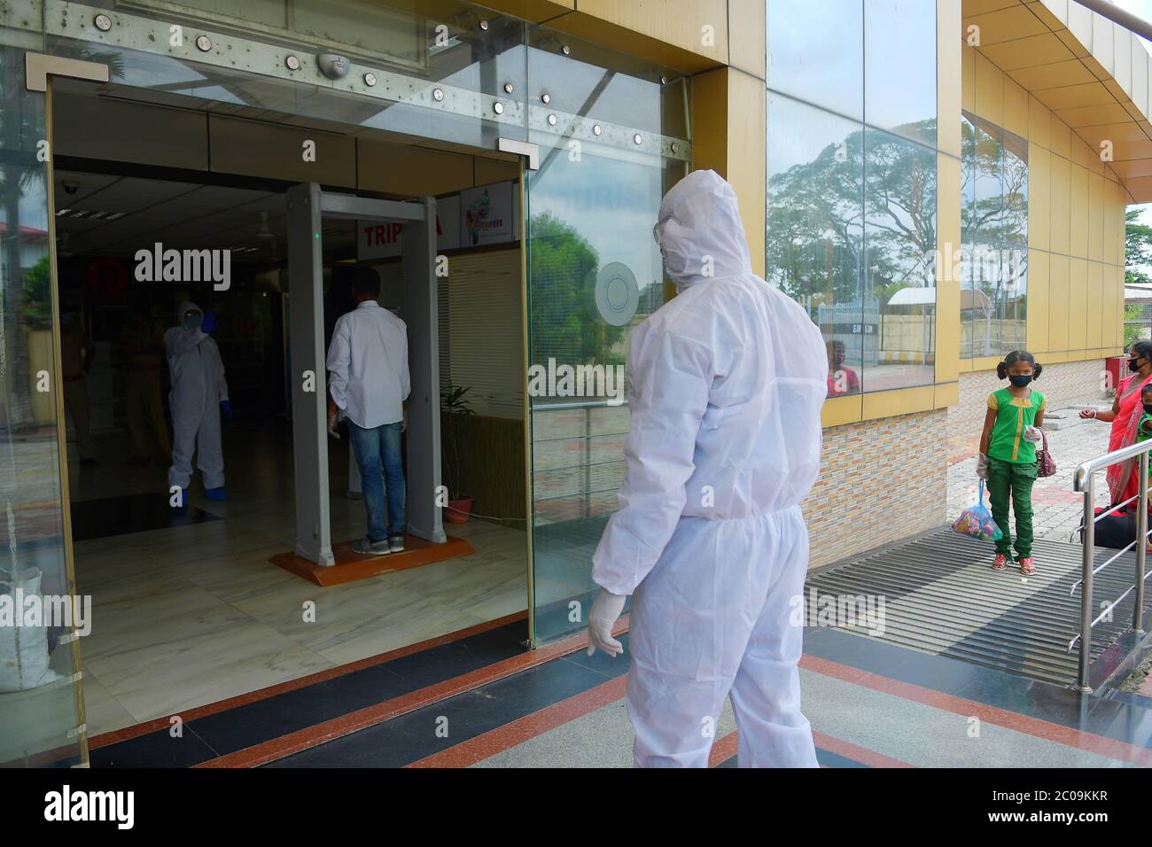 People are waiting in a line to enter Tripura, India through the Akhura ...