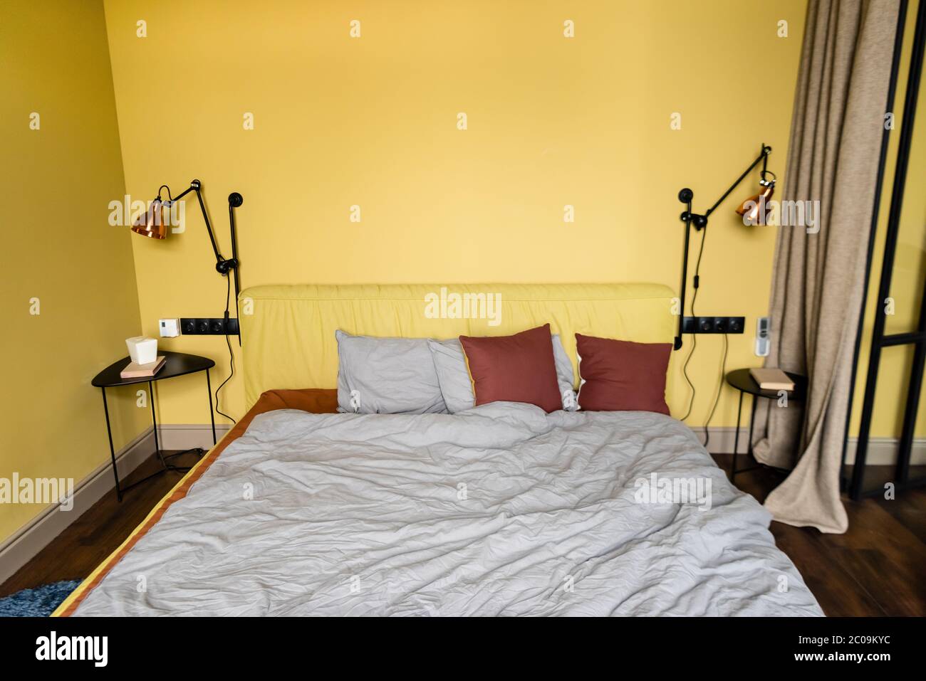 Package with takeaway food and book on bedside table in bedroom Stock ...