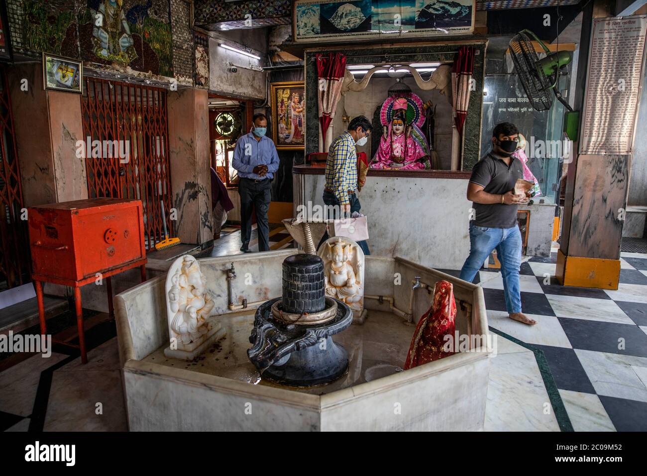 Indian Hindu devotees pray inside Mandir (Temple) after the opening of ...