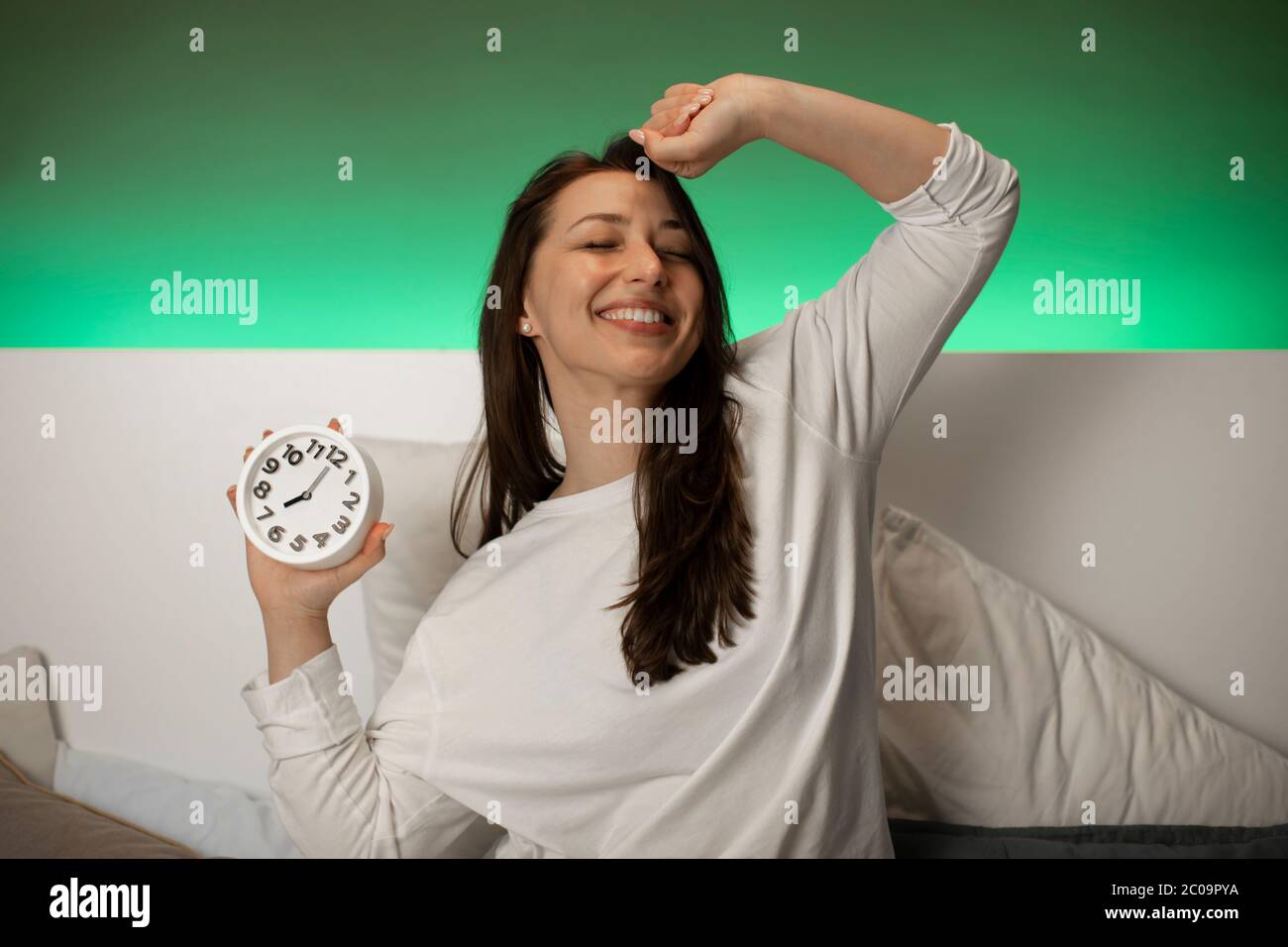 Young attractive female in bed got a good night’s sleep on the weekend ...