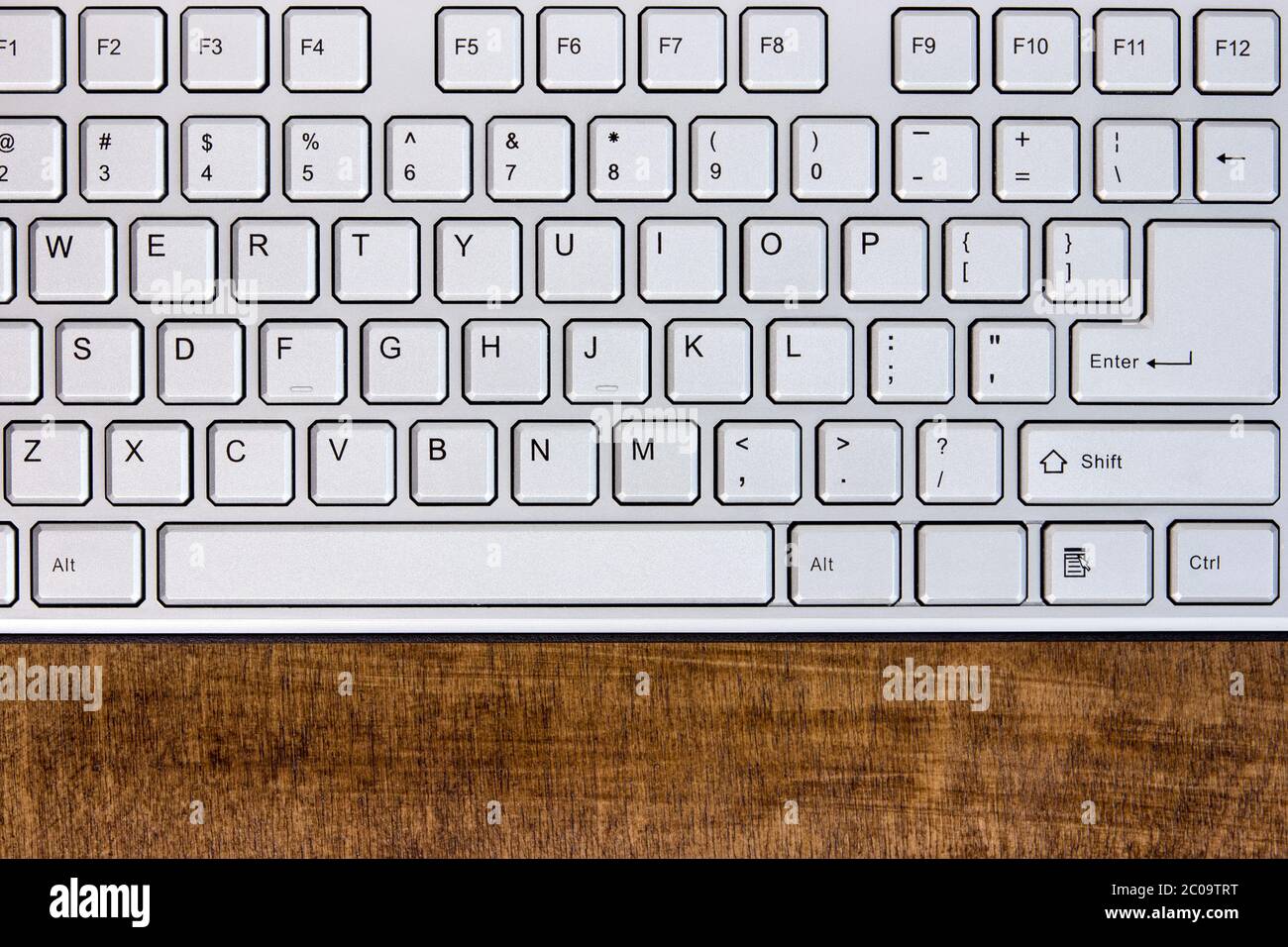 Keyboard on the wooden desk Stock Photo - Alamy